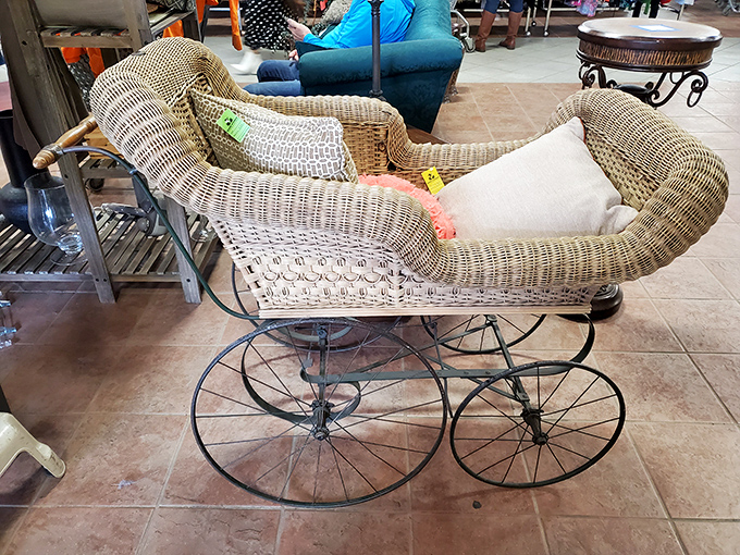 This vintage wicker baby carriage isn't just furniture; it's a time machine to an era of Sunday promenades and proper naps.