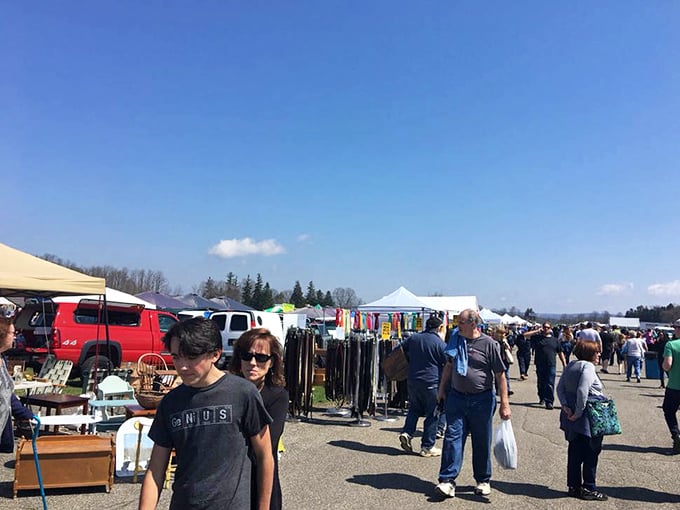 The flea market stretches toward the horizon like a bargain hunter's mirage, white tents gleaming under perfect blue skies.