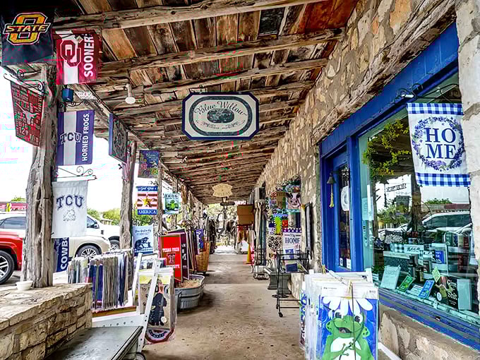 College football flags flutter above rustic walkways, where shopping becomes a treasure hunt through Texas time capsules.