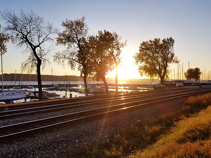 Golden hour transforms Pepin's waterfront into a painter's dream &ndash; where railroad tracks, sailboats, and sunset conspire to create pure magic.