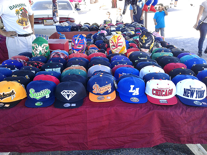 A rainbow of team loyalty spread across the table&mdash;baseball caps representing cities, dreams, and the occasional questionable fashion choice.