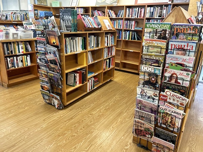 Literary paradise awaits between these wooden shelves, where dog-eared paperbacks and glossy magazines tell stories beyond their printed pages.