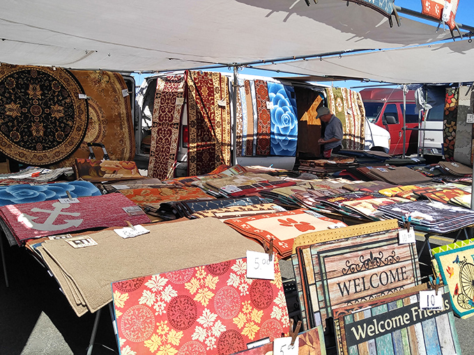 A kaleidoscope of rugs and welcome mats awaits new homes, each pattern telling its own story of craftsmanship and color.