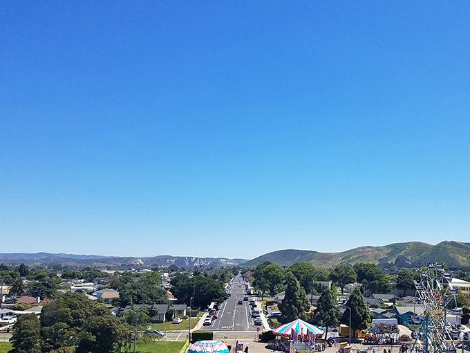 Blue skies stretch endlessly over Lompoc during its annual flower festival, where carnival rides and community spirit bloom together in perfect harmony.