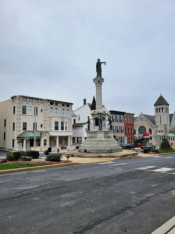 The Civil War monument stands as a dignified sentinel in Pottsville's town center, surrounded by well-preserved buildings that whisper stories of America's past.