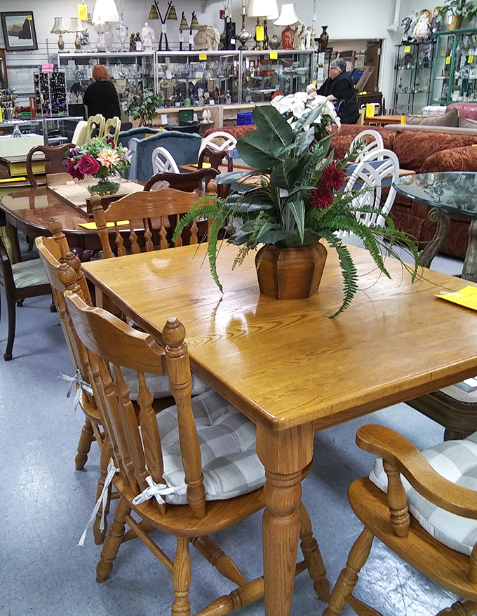 Solid oak dining sets await new homes and future family gatherings. That plant's probably seen more dinner conversations than a talk show host.