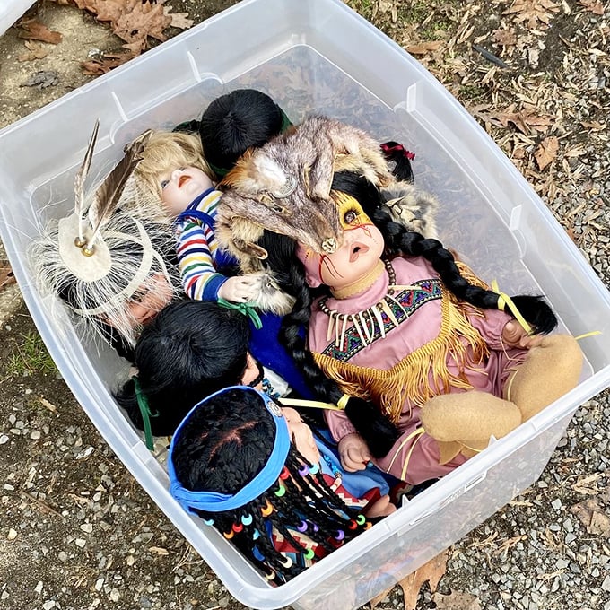 Nostalgia in a plastic bin. These vintage dolls with their Native American-inspired attire wait patiently for collectors or perhaps a second childhood to begin.