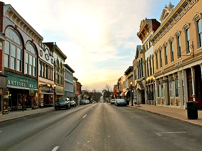 Sunset bathes Shelbyville's historic Main Street in golden light, where Victorian-era buildings house modern treasures&mdash;a living museum where commerce and history coexist beautifully.