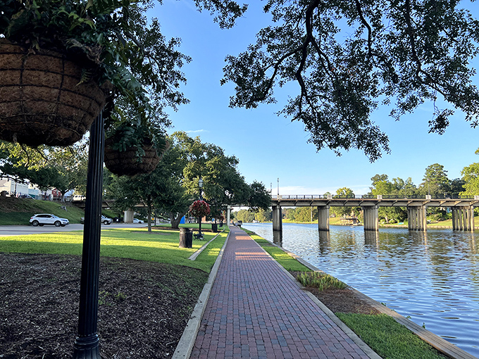 The Cane River waterfront beckons with its brick-lined pathway—nature's retirement amenity that doesn't show up on any cost-of-living calculator.