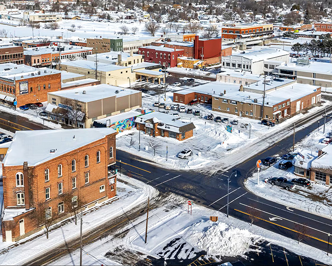 Winter blankets Alpena's historic downtown in snow, transforming brick buildings into a Norman Rockwell painting come to life.