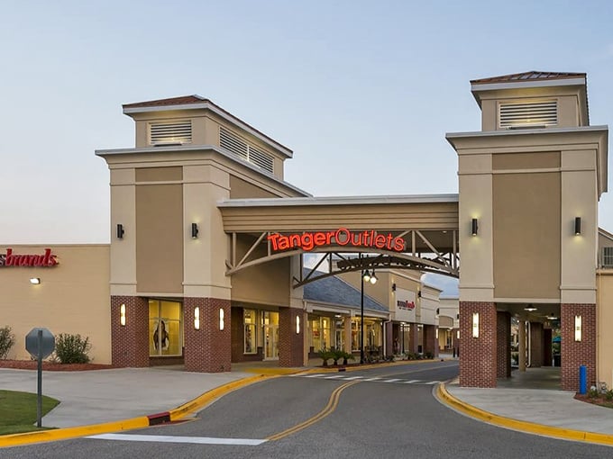 The grand entrance to bargain paradise, where wallets open and shopping bags multiply faster than beach tourists on Memorial Day weekend.