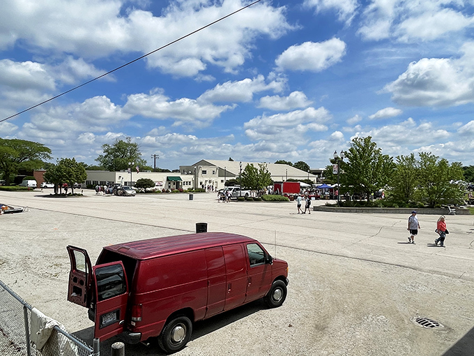 Blue skies and bargains: The Kane County Fairgrounds transforms into a bustling marketplace where red vans deliver treasures and shoppers plot their hunting strategies.