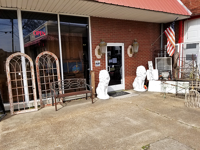 Architectural salvage frames the entrance like a time portal. Those white stone lions aren't just decorative—they're the unofficial gatekeepers to yesterday's treasures.