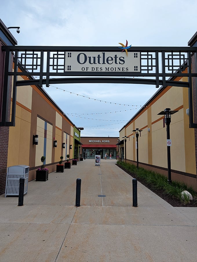 The welcoming entrance arch invites shoppers into a world where credit cards tremble and shopping bags multiply like rabbits.