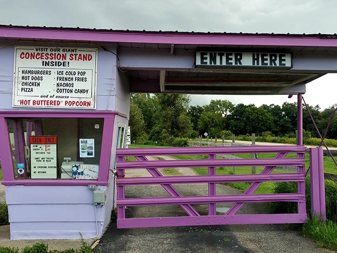 The purple gateway to nostalgia, complete with a menu board promising "HOT BUTTERED" popcorn that deserves those quotation marks.