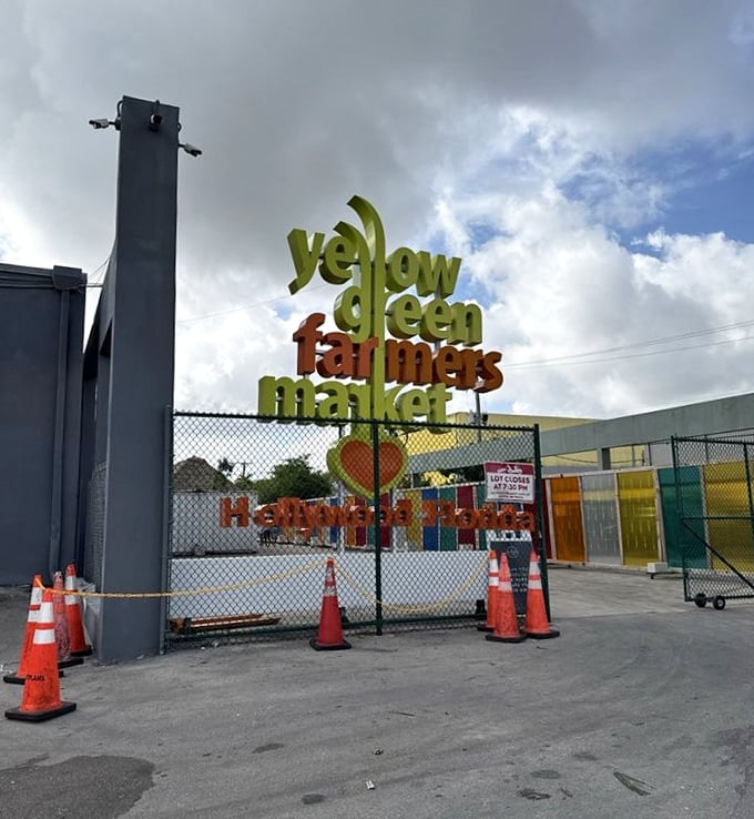 The market's colorful entrance sign promises what lies beyond&mdash;a world where "farmers market" is less a description and more an understatement.