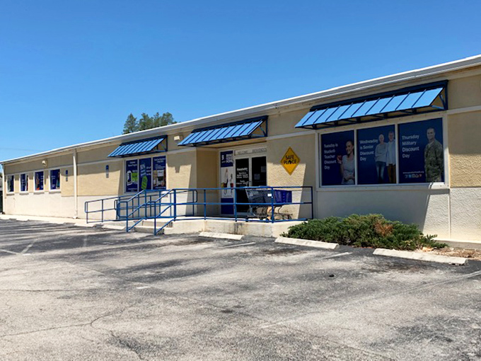 Accessibility meets affordability at the Goodwill Opportunity Center entrance, where Florida sunshine bounces off those distinctive blue awnings like a beacon for thrifters.