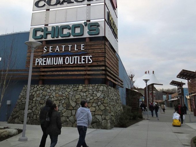 The iconic entrance sign&mdash;where shopping pilgrimages begin and credit cards start their journey toward glorious exhaustion.