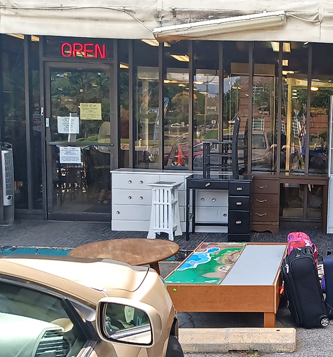 That classic neon "OPEN" sign might as well say "Abandon budget, all ye who enter here." The furniture preview outside is just the appetizer.
