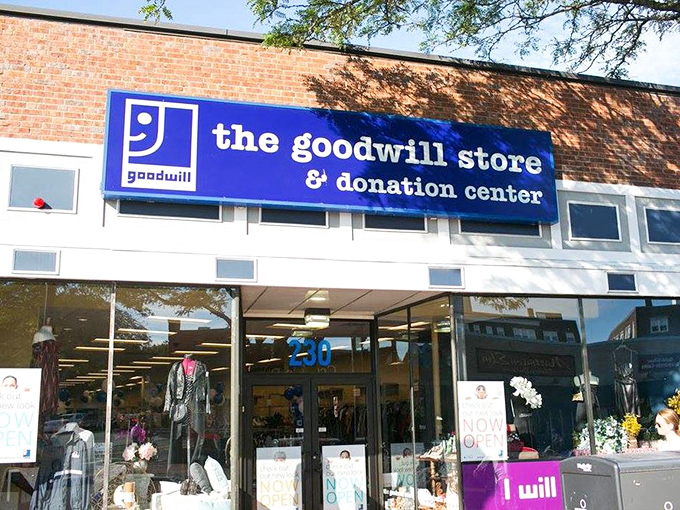 Sunshine bathes the brick facade and distinctive blue signage, where mannequins in the window offer a sneak peek of fashion finds waiting inside.