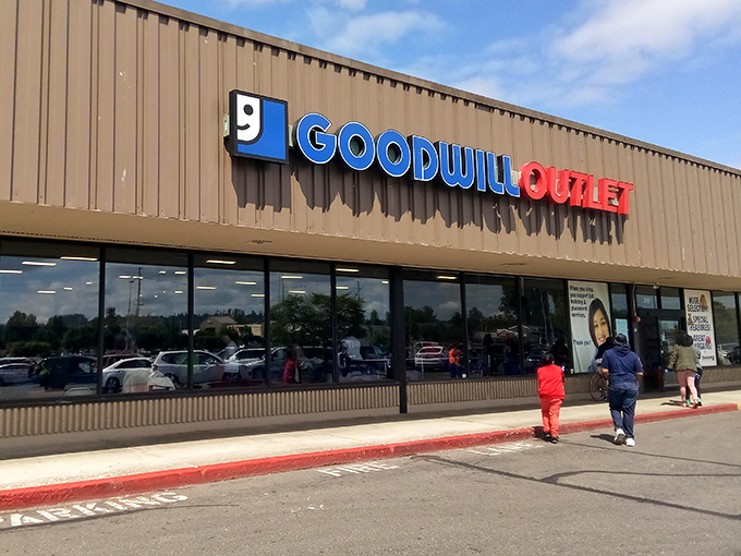 Not just a thrift store, but a full-fledged outlet experience. The Goodwill Outlet's bold signage announces itself as a destination for serious treasure hunters.