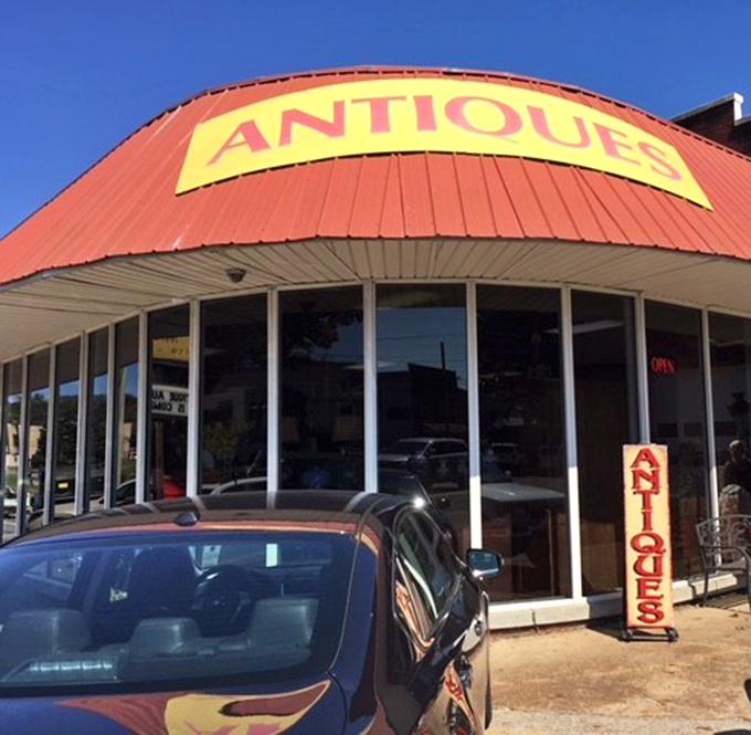 That red roof and bold yellow "ANTIQUES" sign is like a beacon for bargain hunters. No pretension here, just pure nostalgic bliss waiting inside.