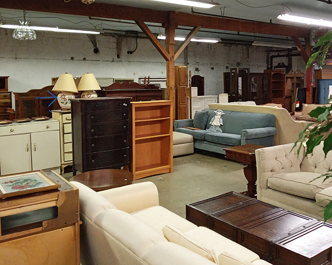 Furniture heaven awaits! That teal sofa could tell stories from another era, while those wooden dressers stand ready for their second act in your home.