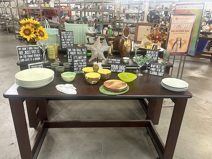 Colorful dishes and witty signs create a tabletop vignette that whispers, "Your dinner parties could use a dash of vintage charm and conversation starters."