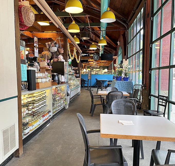 Warm yellow pendant lights hang from wooden beams, creating that perfect "I've discovered something special" atmosphere that makes regulars out of first-timers.