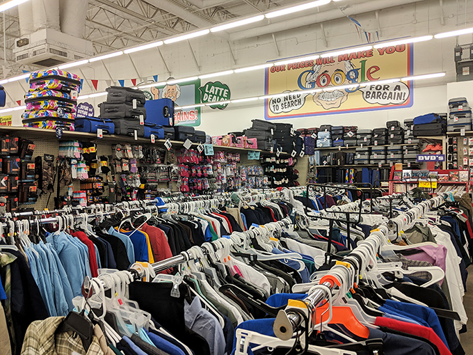 Clothing racks stretch toward the horizon like a textile Grand Canyon. That humorous sign promising Google-worthy prices adds the perfect touch of retail humor.