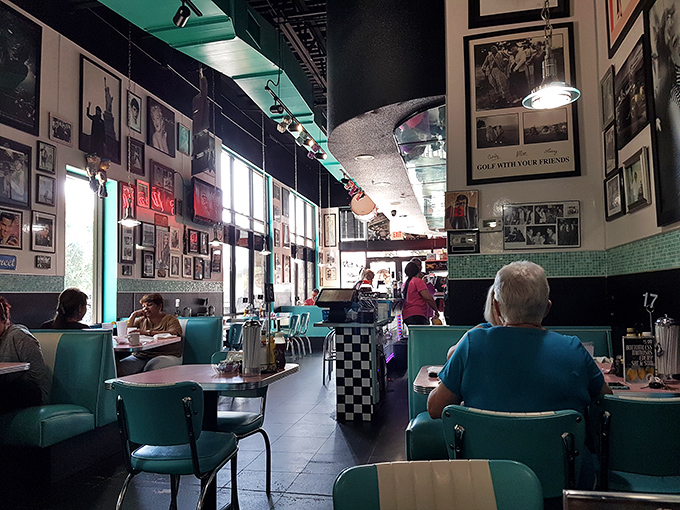 Step into a time warp where turquoise booths meet memory-filled walls. This isn't decoration&mdash;it's a love letter to American pop culture.