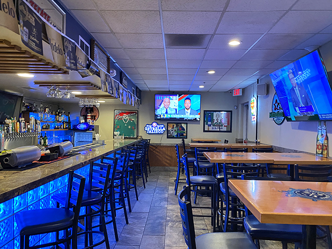 The bar area strikes that perfect balance between sports hangout and seafood sanctuary, with blue lighting that makes you feel like you're dining underwater.