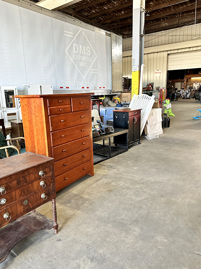 Solid wood furniture awaits new homes in the warehouse section. That cherry dresser has probably seen more family dinners than most Thanksgiving turkeys.