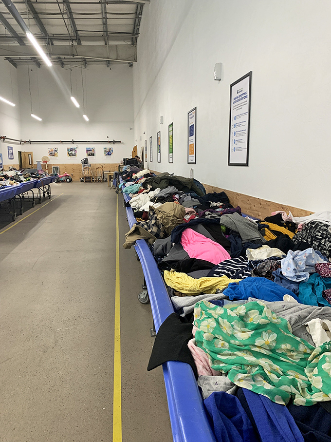 Industrial chic meets thrift store realness. The no-frills warehouse setting strips away retail pretense, leaving nothing but the pure adrenaline rush of the hunt.