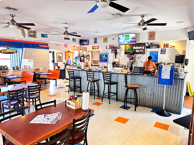 No-frills interior with orange accents and corrugated metal counter&mdash;barbecue joints with ceiling fans always seem to have the best food.