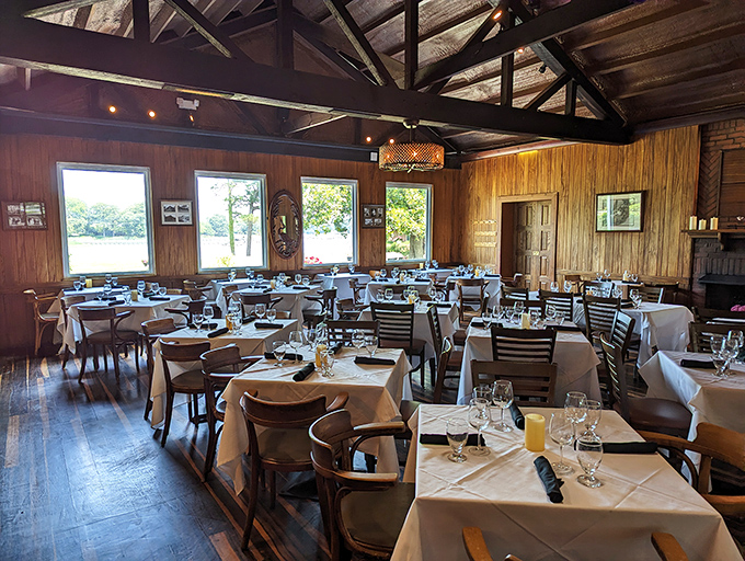 Wood-paneled warmth meets white tablecloth elegance—this dining room has hosted first dates that turned into 50th anniversaries.