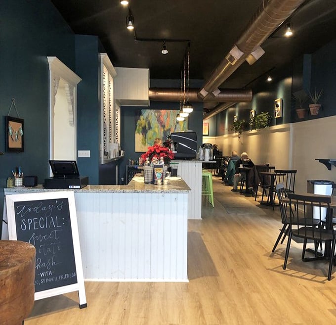 Modern meets cozy in this thoughtfully designed space. The teal walls and wooden floors create the perfect backdrop for food that demands your full attention.