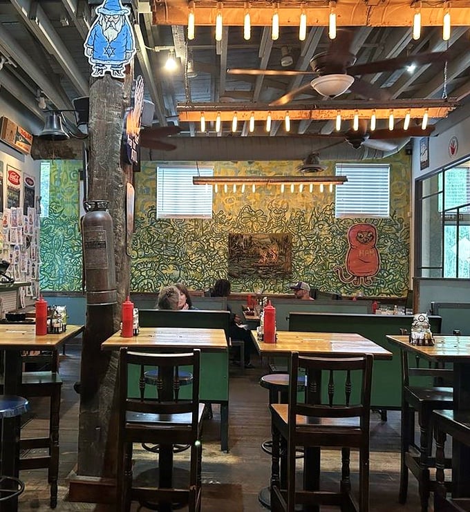 Inside, wooden beams and quirky wall art create the perfect backdrop for life-changing breakfast decisions. The green mural practically winks at you.