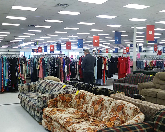 A treasure hunter's paradise where colorful banners guide you through aisles of possibilities and floral-patterned furniture awaits new homes.