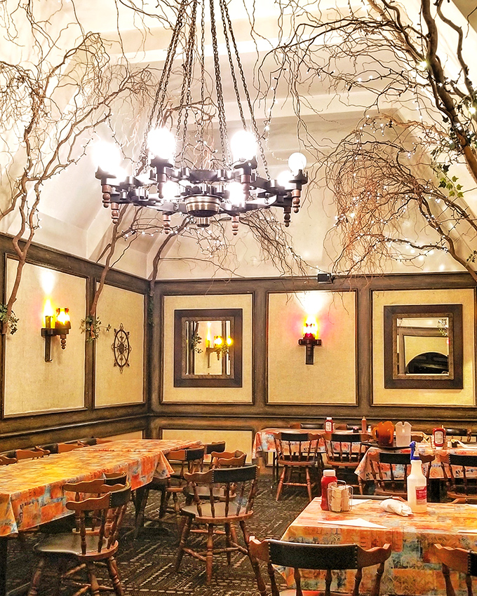 Step inside and you're transported to a rustic wonderland where twisted branches dance across the ceiling and chandeliers cast the perfect "make everyone look good" lighting.