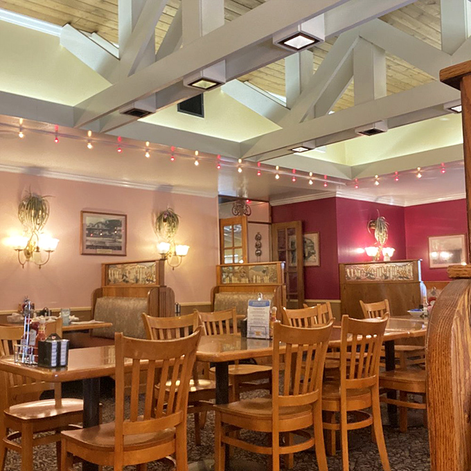 Wooden beams, warm lighting, and burgundy walls create that rare dining atmosphere where you instantly feel like kicking off your shoes and staying awhile.