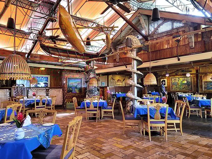 Polynesian elegance meets maritime history. The dining room's soaring ceilings showcase vintage canoes that make you wonder if your seafood might arrive via outrigger.