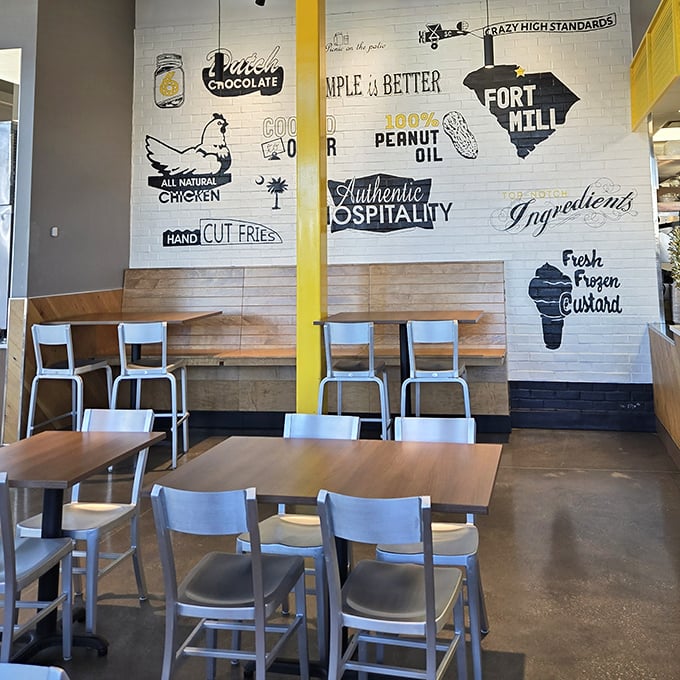 The wall art tells you everything you need to know: all-natural chicken, hand-cut fries, and a commitment to quality that's literally written on the wall.