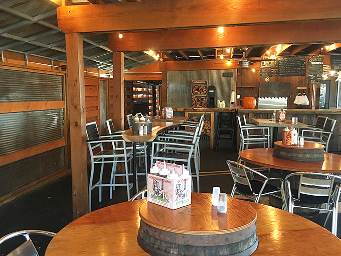 Edison bulbs cast a warm glow over barrel-top tables, creating the perfect rustic-chic backdrop for the meat feast to come.