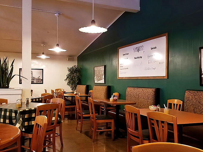 Green walls, wooden chairs, and pendant lights create the perfect no-nonsense atmosphere where the food, not the decor, rightfully takes center stage.