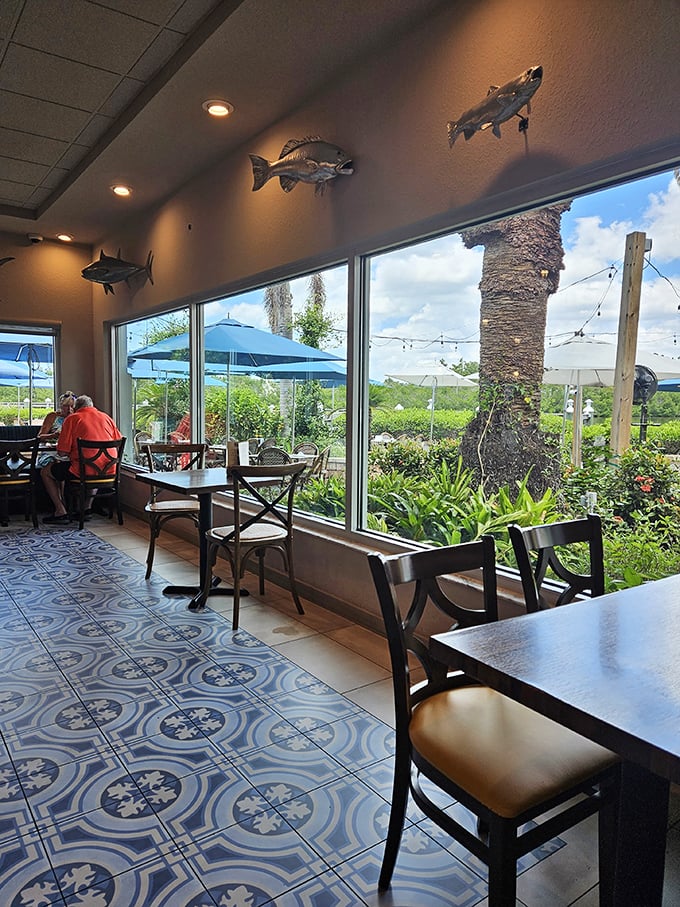 Fish mounts watch over diners like culinary guardian angels while floor-to-ceiling windows frame nature's artwork&mdash;Florida's waterways and swaying palms.