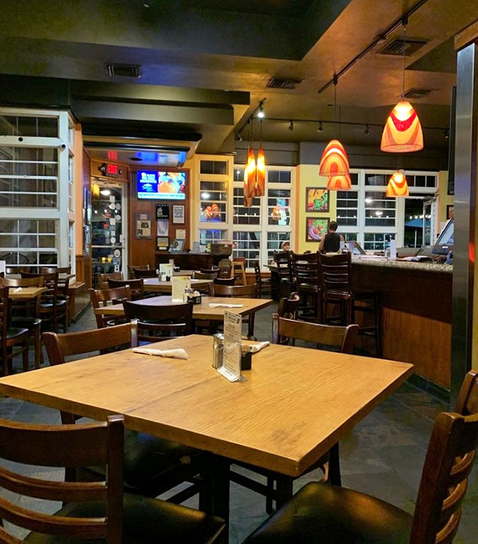 Warm wooden tables bathed in the glow of distinctive orange pendant lights create that rare atmosphere&mdash;sophisticated yet completely unpretentious.