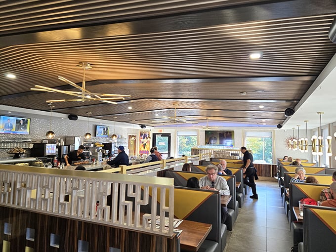 Modern meets classic in this thoughtfully designed interior. The wood-paneled ceiling adds warmth while those yellow booths practically whisper "slide in and stay awhile."
