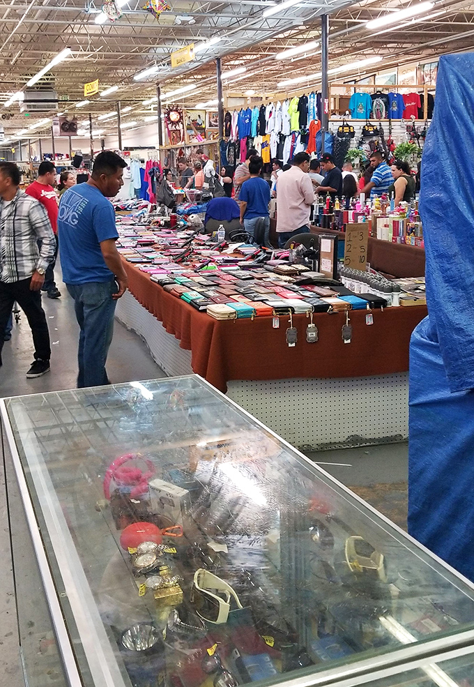 Inside, the marketplace unfolds like a retail fever dream. Tables laden with merchandise stretch toward the horizon, promising discoveries at every turn.