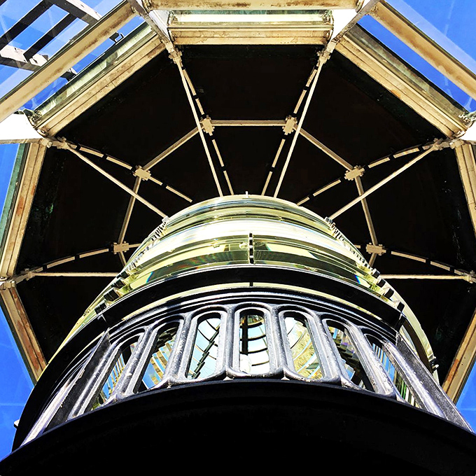 Looking up through the lighthouse's intricate brass framework feels like peering into a steampunk time machine that once guided sailors safely home.